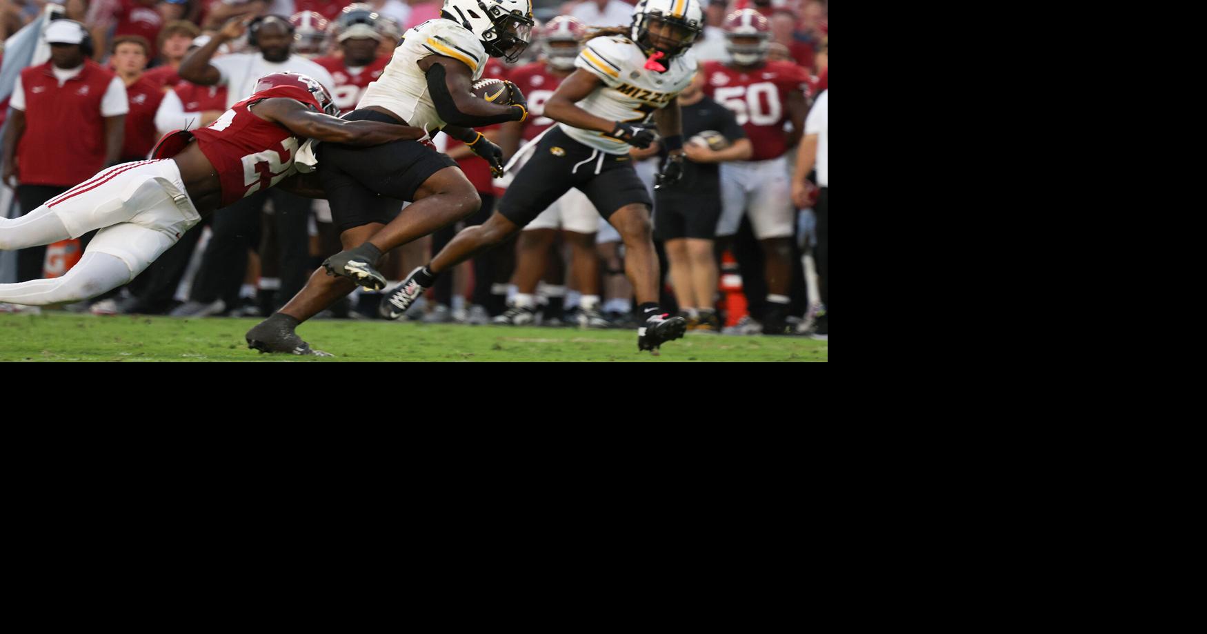 Mizzou running back Marcus Carroll is tackled by Mizzou cornerback Ja ...