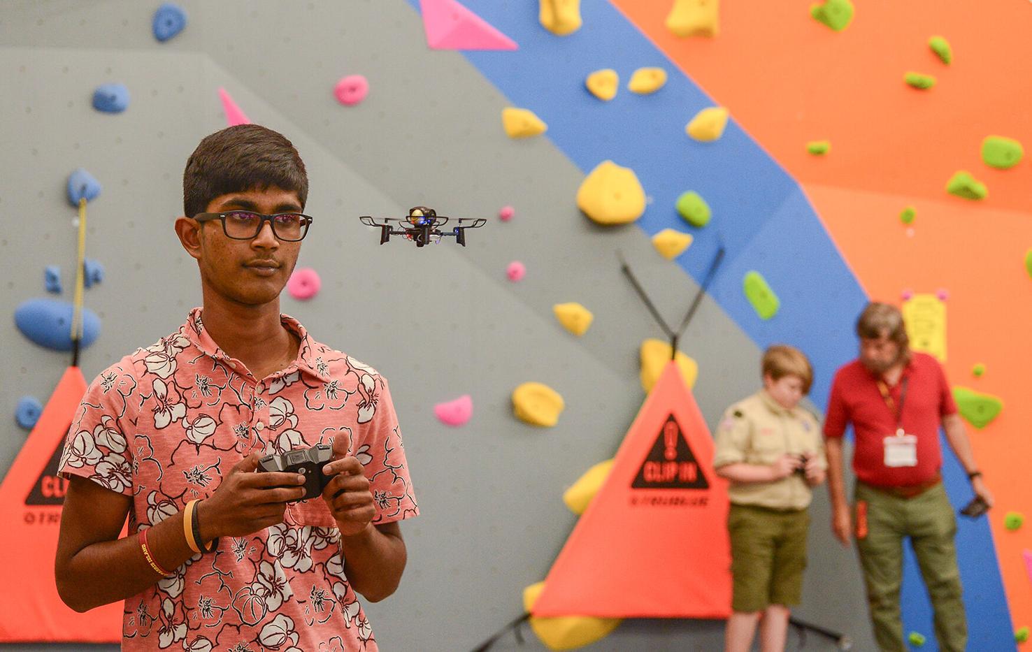 From left, Joseph Cherian flies his newly built drone, while Jamison ...