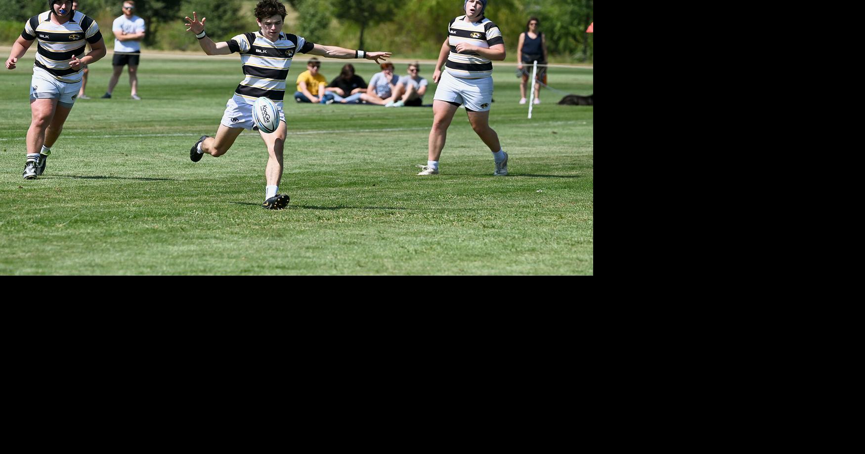 Mizzou Men’s Rugby Club team members Logan Lair, center, kicks the ball ...