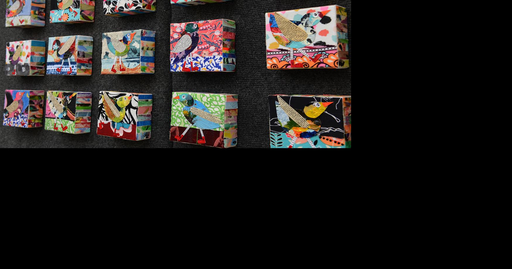 Small canvases of mixed media art hang on the wall of Carolyn Lewis ...