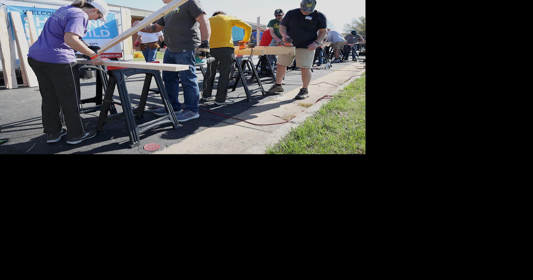Susan Sappington (left) and John Bunch sand planks that will eventually ...