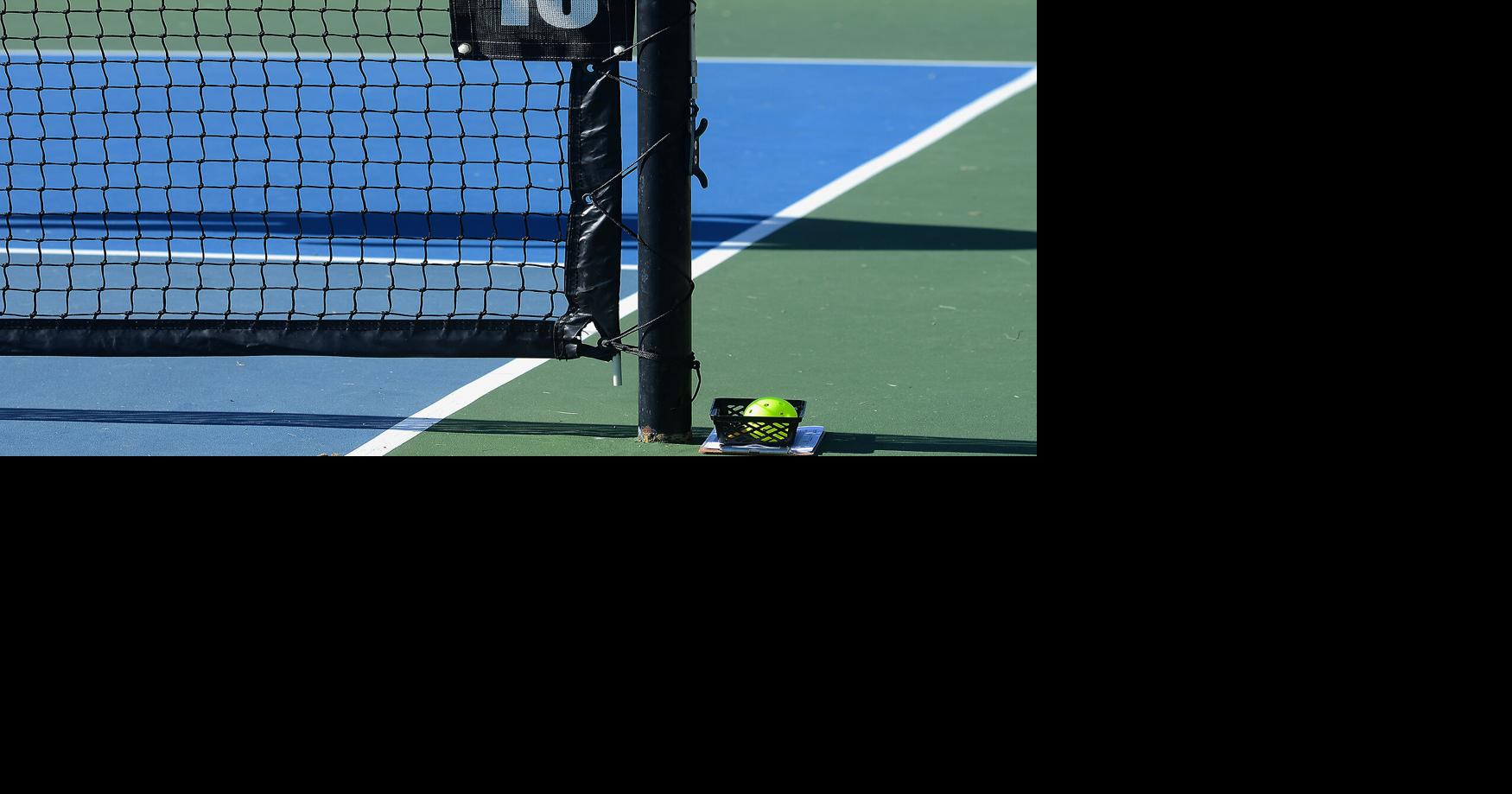 Two balls and a tournament book sit in a basket | Visuals ...
