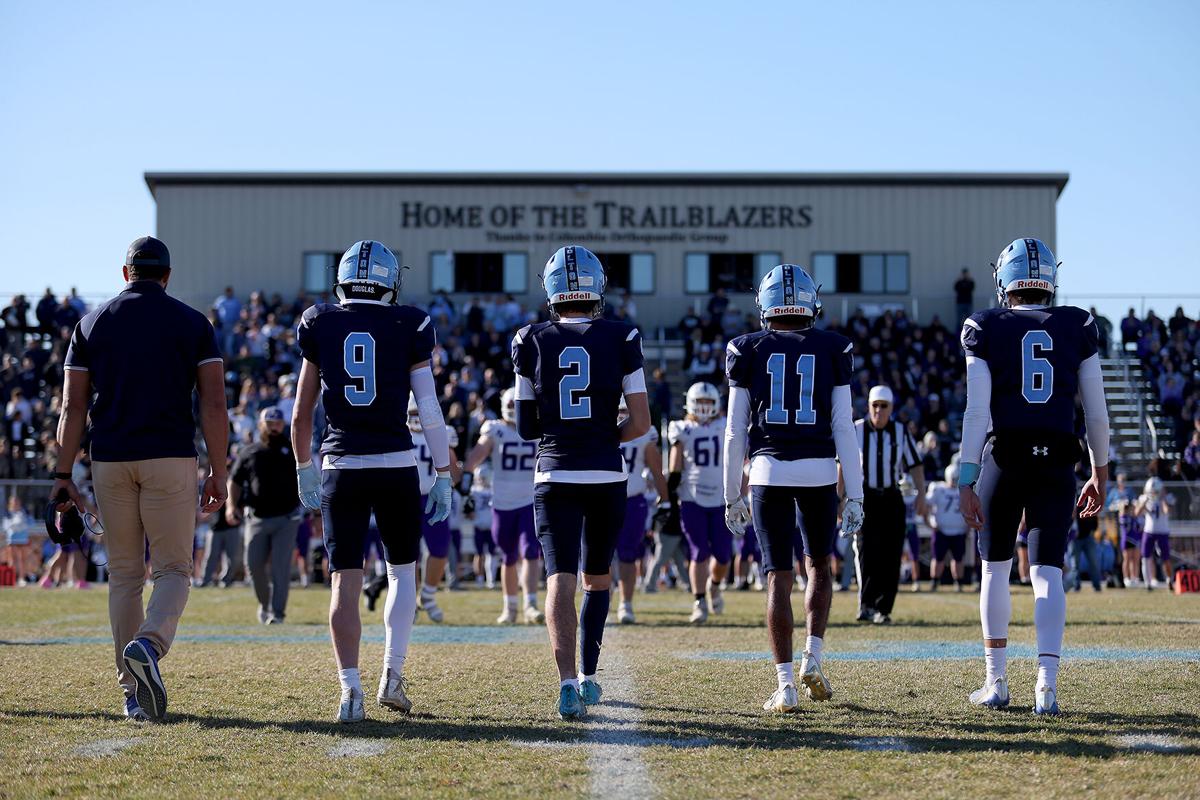Father Tolton head coach Michael Egnew walks onto the field for the ...