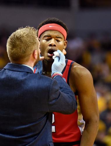A trainer tends to Ole Miss guard Devontae Shuler | Photos ...