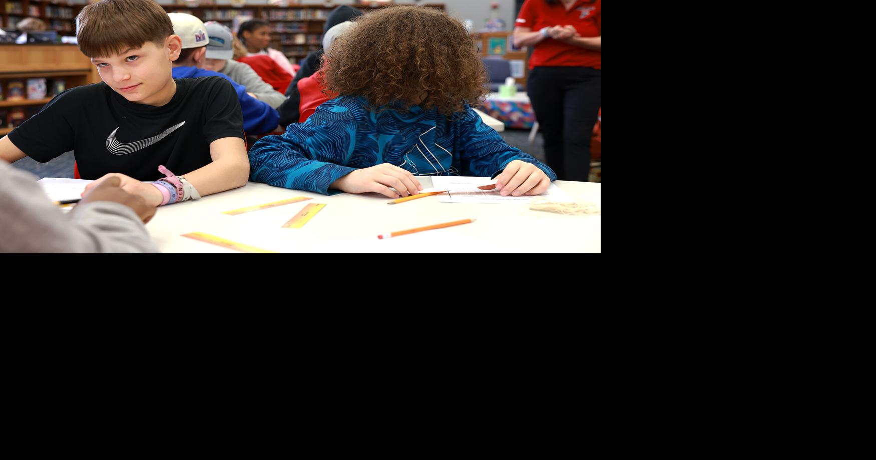 Turner Burks and Cas Boltz listen to instructions for a Pi Day math ...
