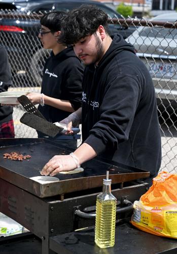 Jacob Prosper grills food Thursday | Sports | columbiamissourian.com