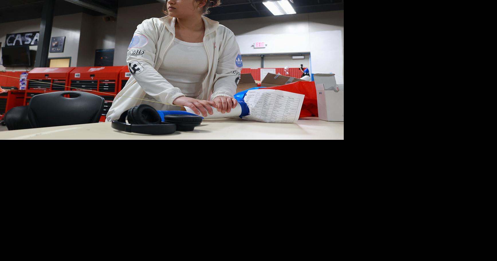 Hickman High School senior Alex Renoe helps a fellow student test a ...