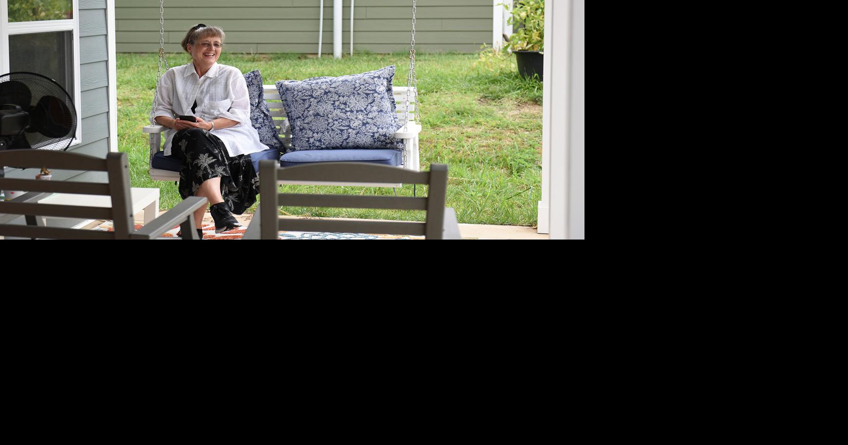 Deb Burling, a community member of Ash Court neighborhood, sits outside ...
