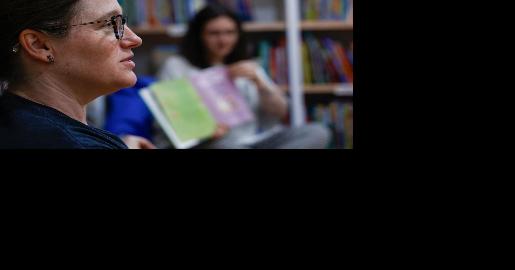 Carrie Koepke, left, Skylark Bookshop co-founder, listens while ...