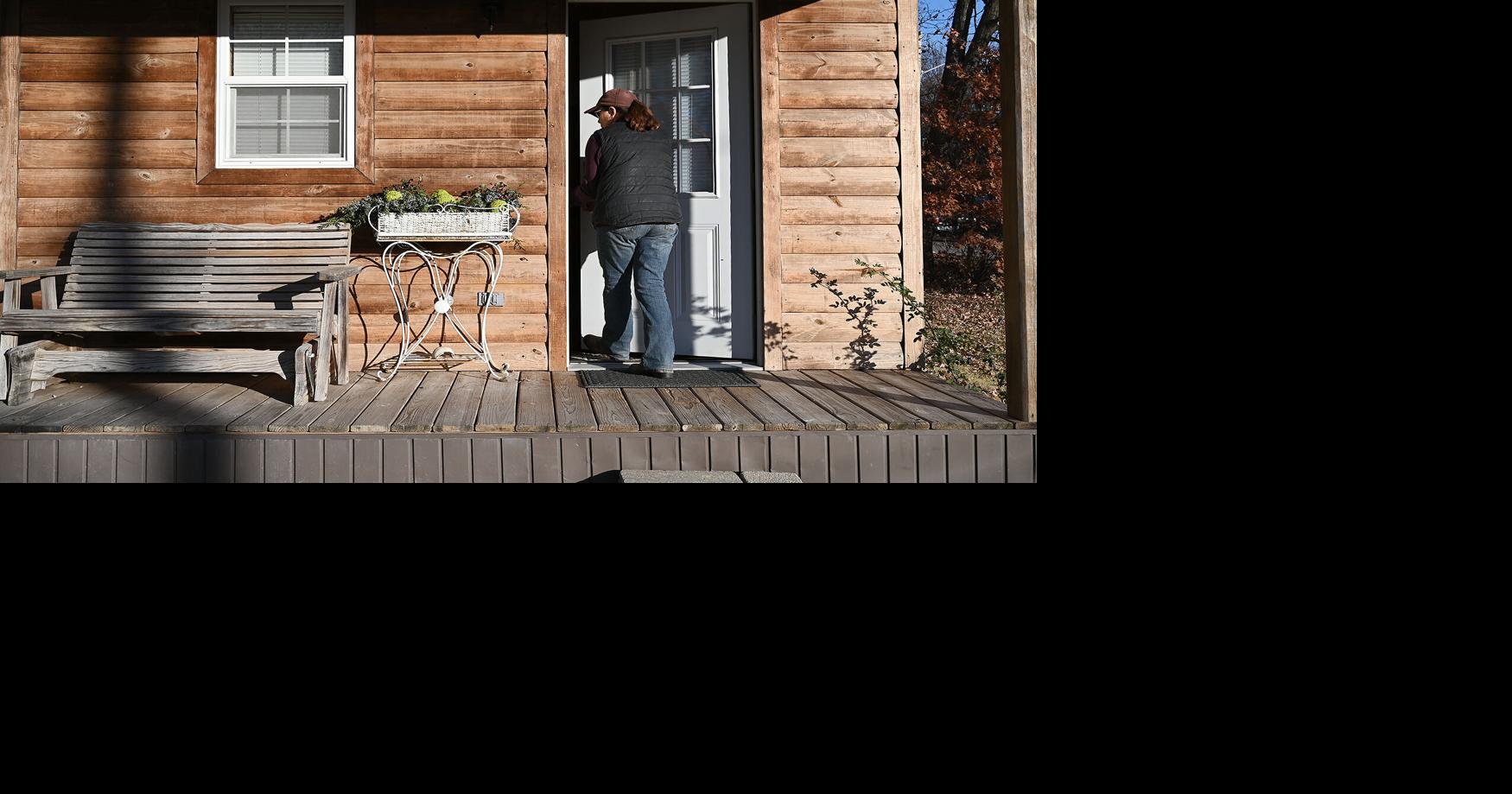 Kim Henderson closes the door of one of her cabins | News ...