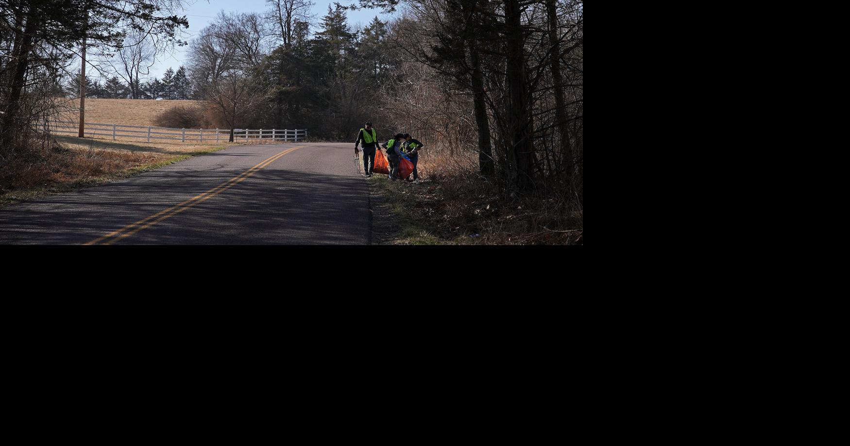 From left, Joel Poor, Starkie Kreuder, and Meg Trull pick up trash ...