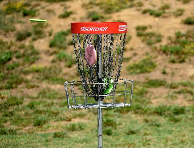 Disc golfers compete during the first round of the Mid America Open ...