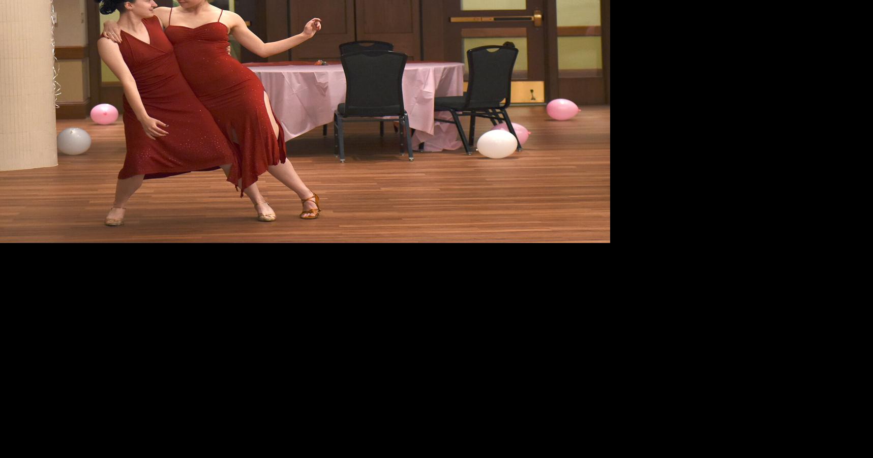 Kira Bennett, left, holds Natalie Anne Heath as she dips into her side ...