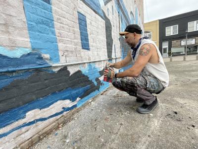 Artist Dowdle painting his third mural in downtown Hertford | Feature ...