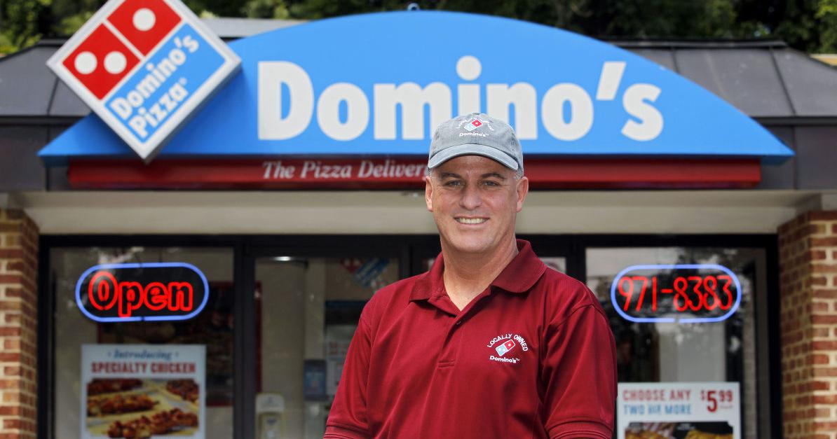 A proud pizza proprietor