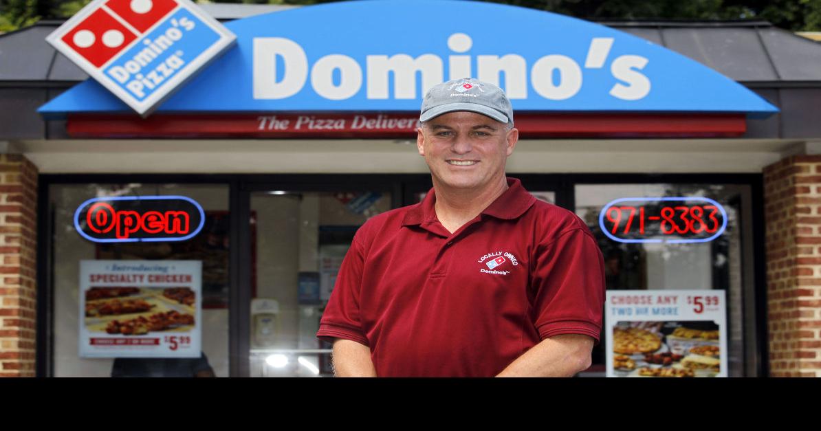 A proud pizza proprietor