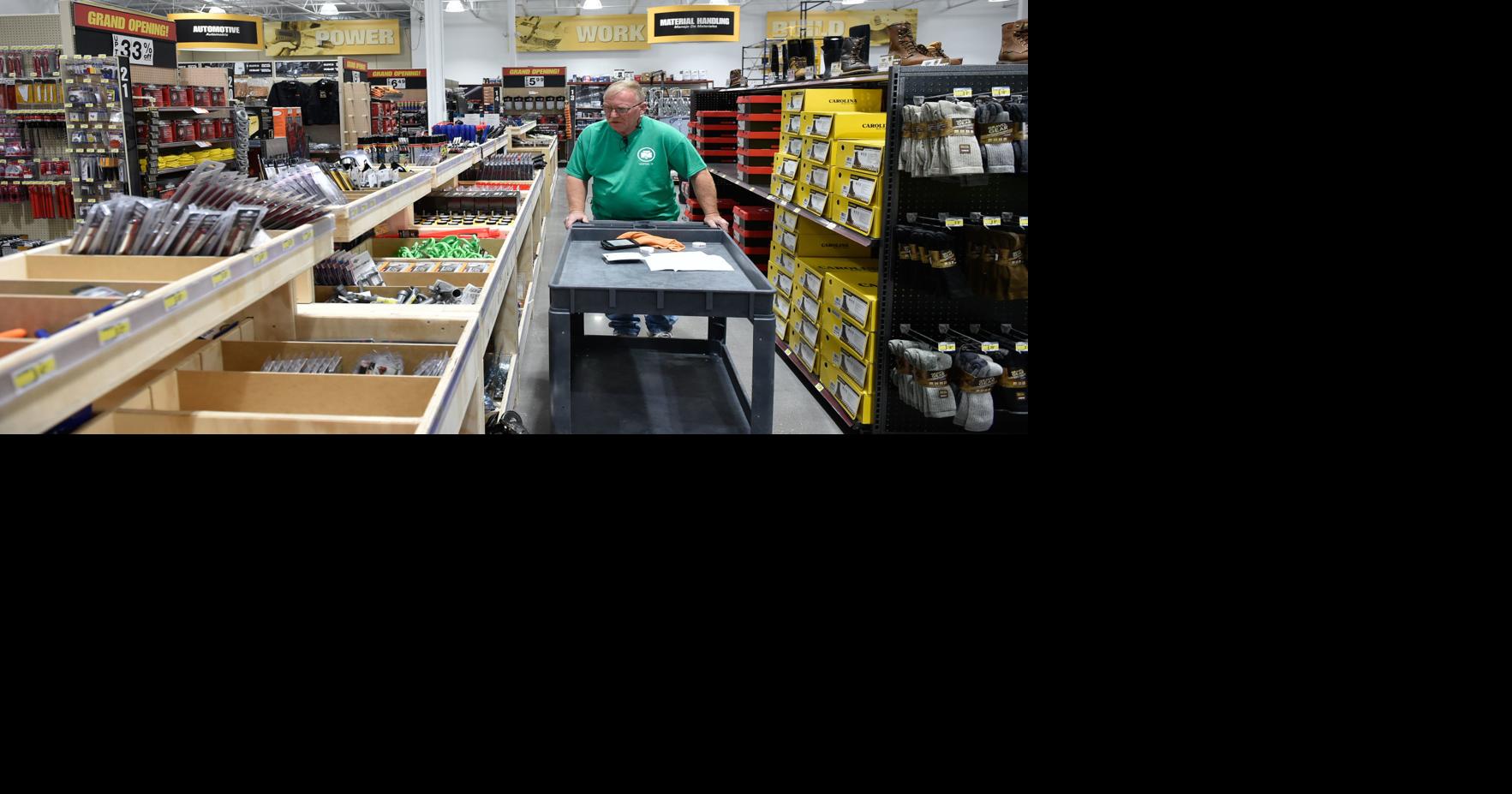 Employee Bobby Travis tidies up the store during a soft opening at ...