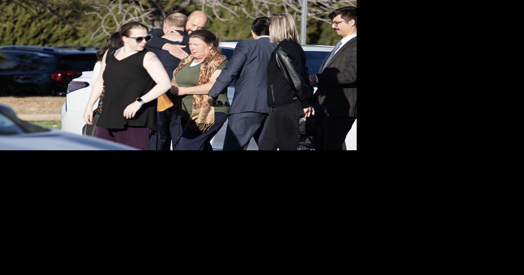 Aurora Police Officer Nathan Woodyard Center Left Embraces A