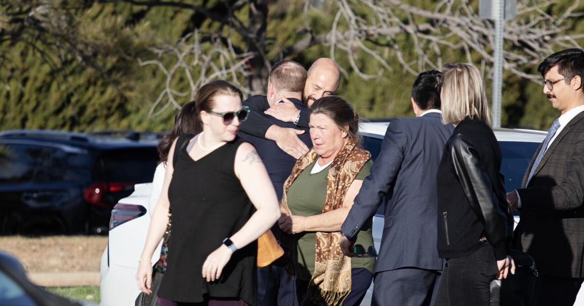 Aurora Police Officer Nathan Woodyard Center Left Embraces A