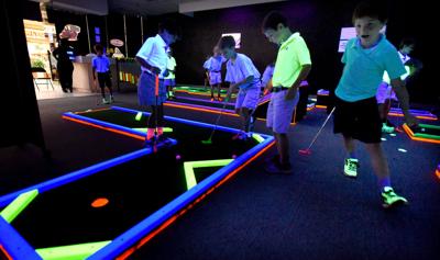 Miniature black light golf course now open in Dothan mall