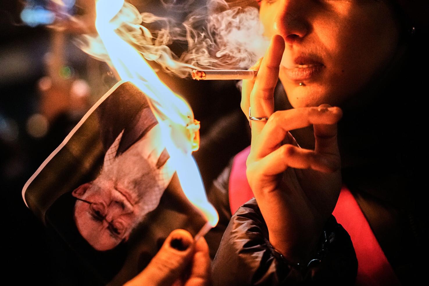 Woman burns photo, lights cigarette and becomes a symbol