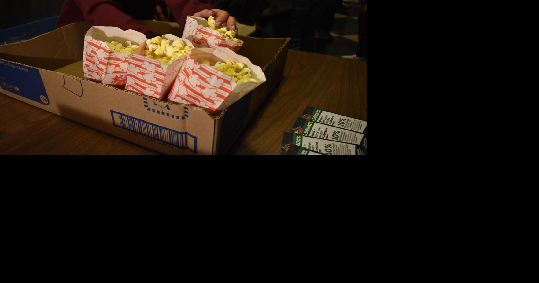 Senior Chan Thuy hands out pre-packaged popcorn for incoming students ...