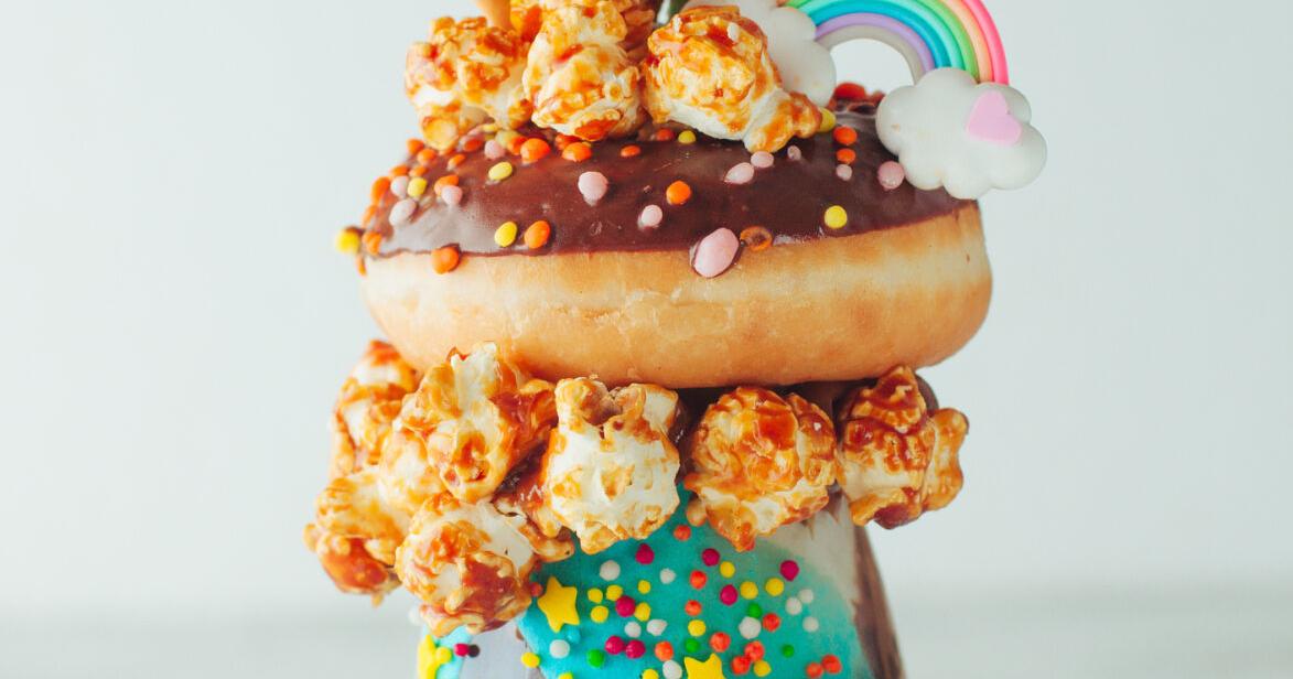 Chocolate freak shake topping with donut and caramel popcorn on the ...