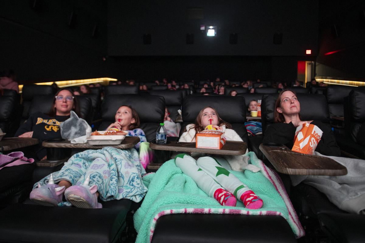 Families enjoy free popcorn, a cozy movie in their pajamas at Warehouse ...