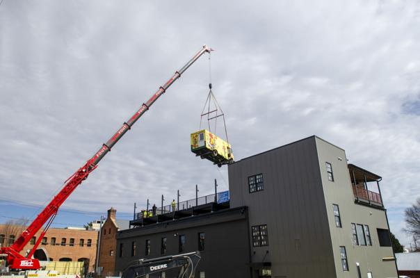 Crane lifts food truck onto rooftop of new downtown Frederick ...
