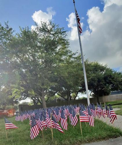 The lawn of fire station number 4 in League City covered with flags for ...