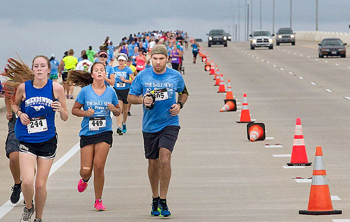 Runners hit the causeway to put newspapers in schools | Local News ...