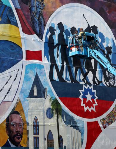 Artists paint additions to 'Absolute Equality' mural in Galveston ...