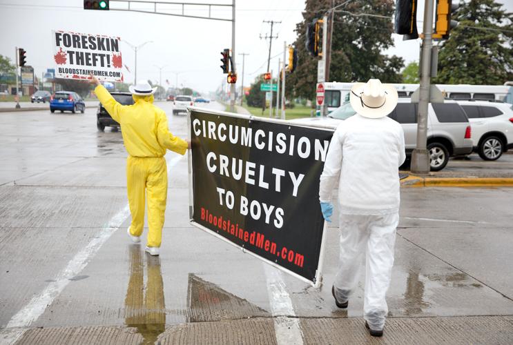 Anti-circumcision protest group The Bloodstained Men come to one of ...