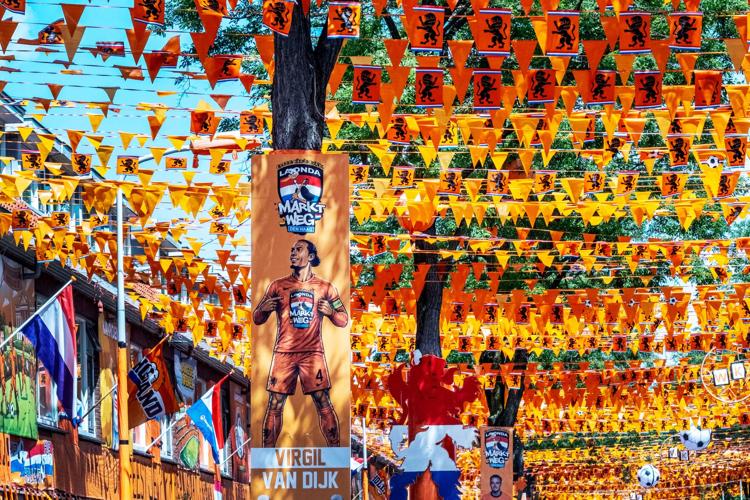 A street in The Hague is drenched in orange as Netherlands soccer fans ...