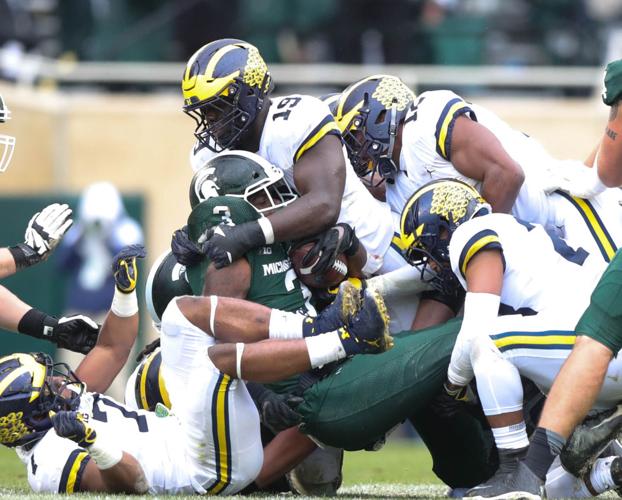 Michigan football powers through rival Michigan State in emotional ...
