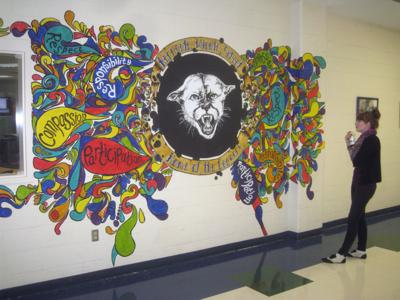 Artist paints mural of Kernodle Middle School mascot