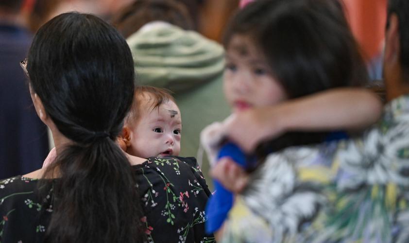 Catholics receive a cross of ashes on their foreheads on Ash Wednesday ...