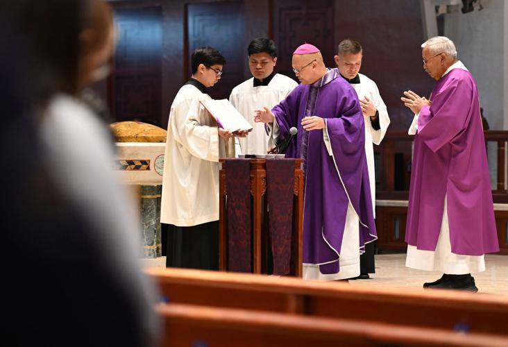 Catholics receive a cross of ashes on their foreheads on Ash Wednesday ...