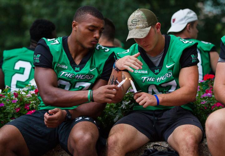 Photos: Candlelight vigil for former Marshall quarterback Reggie Oliver ...
