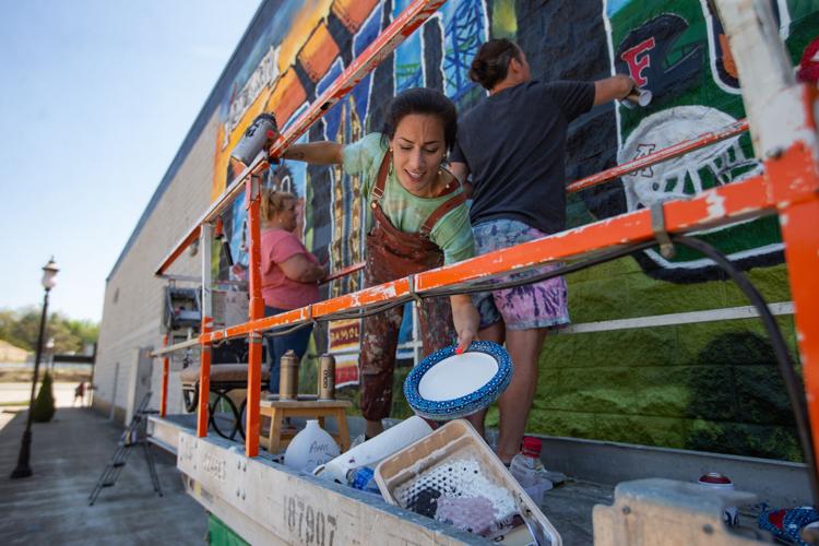 Artists return to hometown to paint mural | News | herald-dispatch.com
