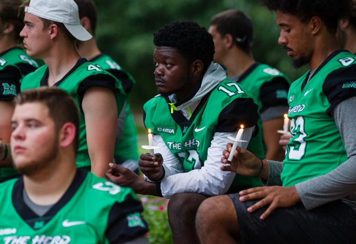 Photos: Candlelight vigil for former Marshall quarterback Reggie Oliver ...