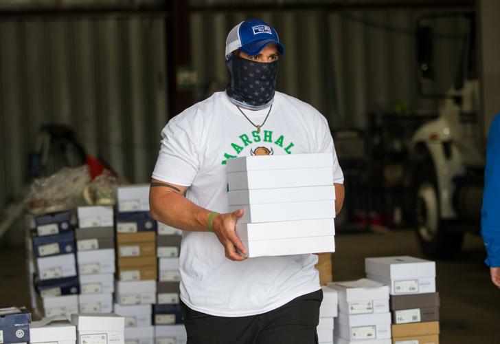 Former NFL player returns to host shoe distribution | News | herald ...