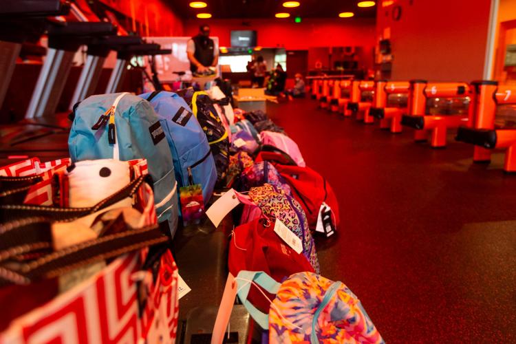 Photos: Volunteers pack bags for donation at Orangetheory Fitness ...