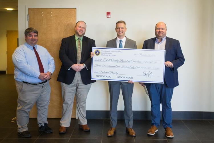 State Treasurer Riley Moore presents unclaimed property checks to local ...