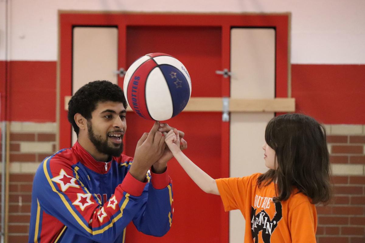Harlem Globetrotter Sweet Lou II visits kids in Huntington school ...