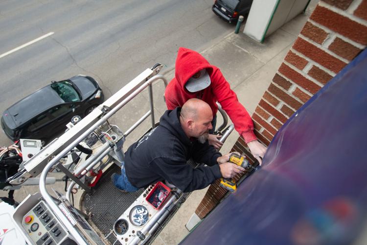 Don't look down: Employees add signage to Marshall parking garage ...
