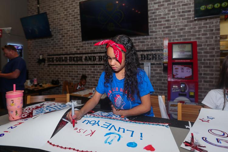 Photos: Watch party for Olympian McKenzie Long's 200-meter final run ...