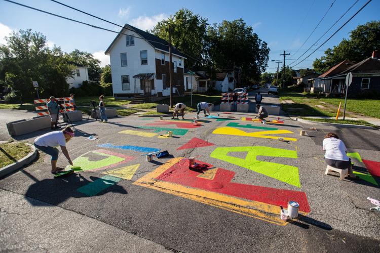 Volunteers help bring neighborhood asphalt art projects to life | News ...