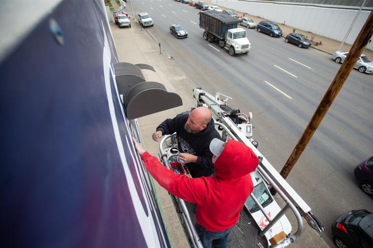 Don't look down: Employees add signage to Marshall parking garage ...