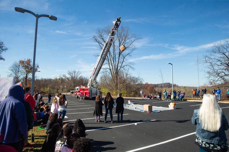 HEMS students work together to protect falling pumpkins | News | herald ...
